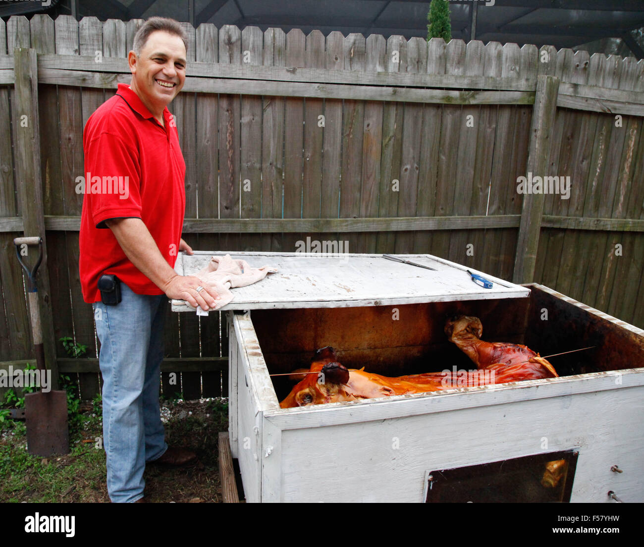 A dramatically Crispy Roasted Pig, being prepared to be removed from it ...
