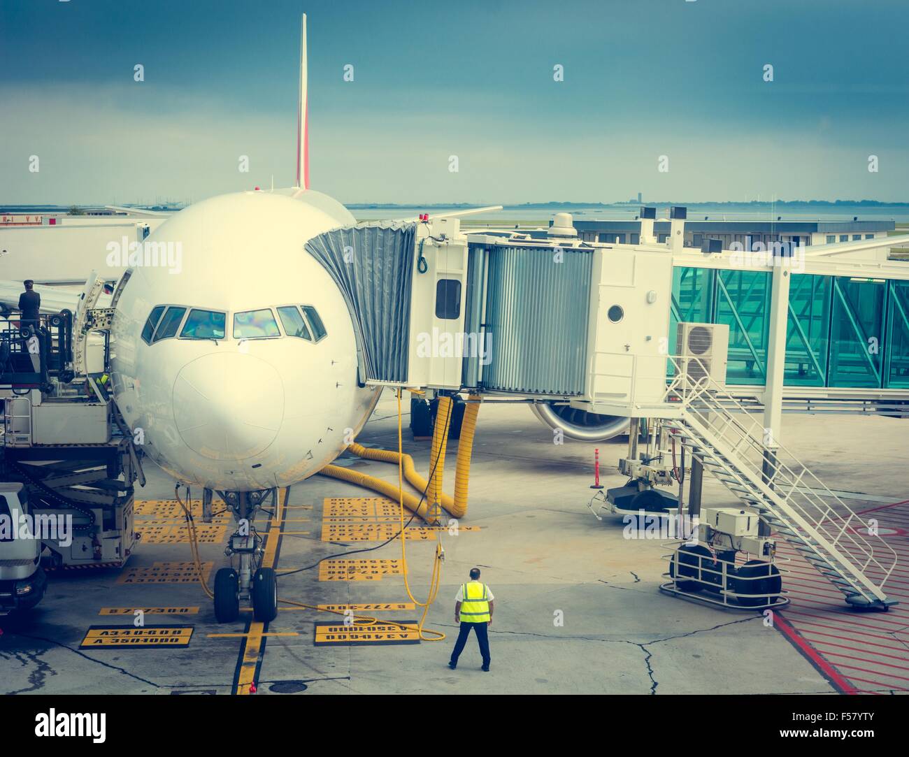 Airplane docked to terminal Stock Photo - Alamy