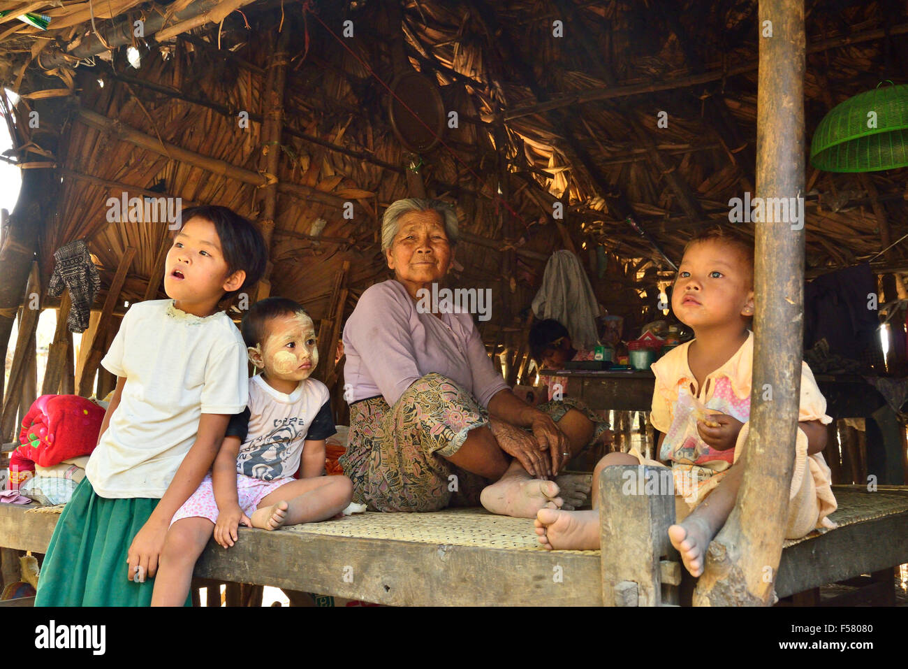 Burmese grandmother looking after children in Shwe Pyi Thar village ...