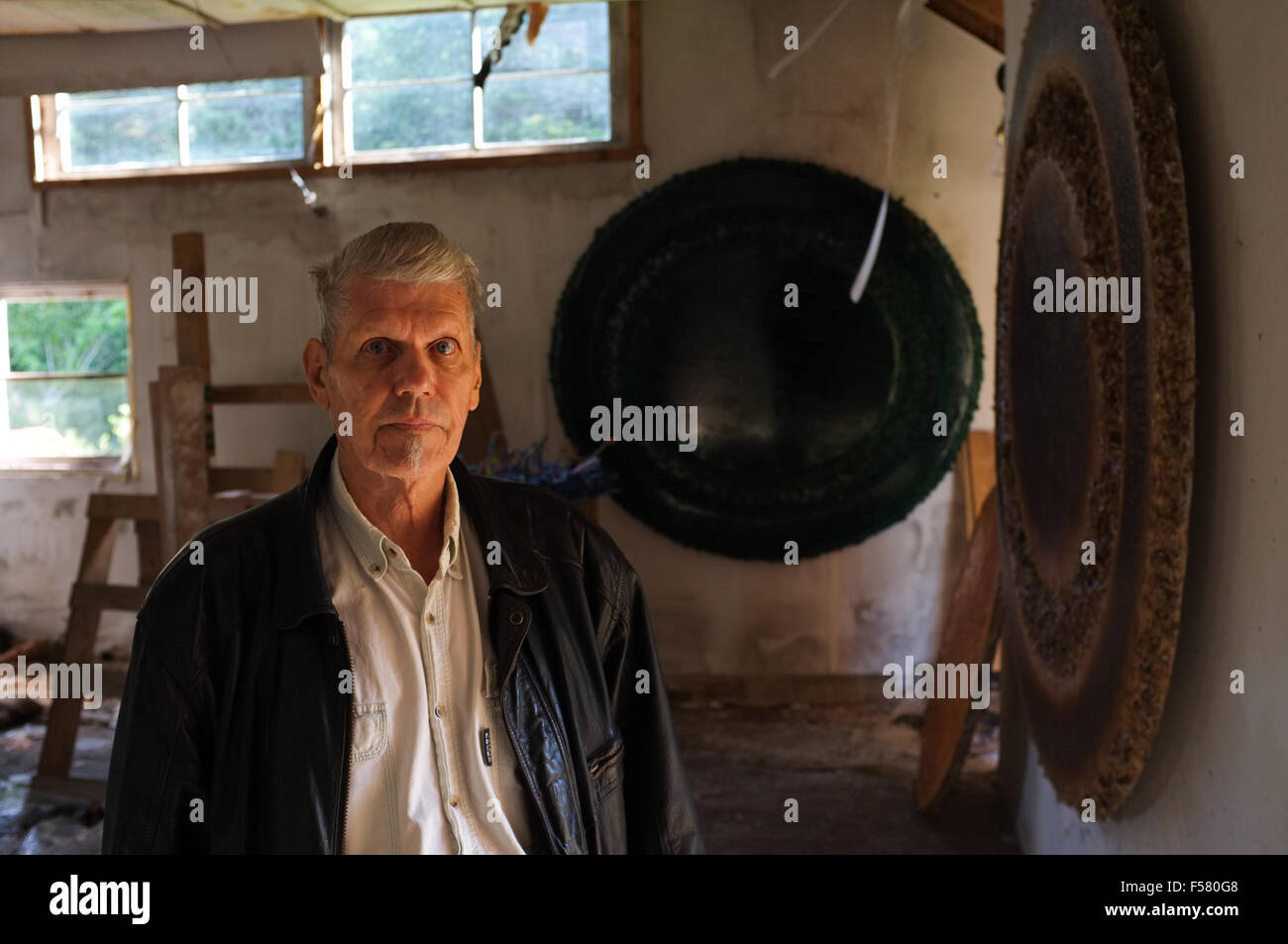 Canadian artist Terrence Syverson poses with some of his art work at ...