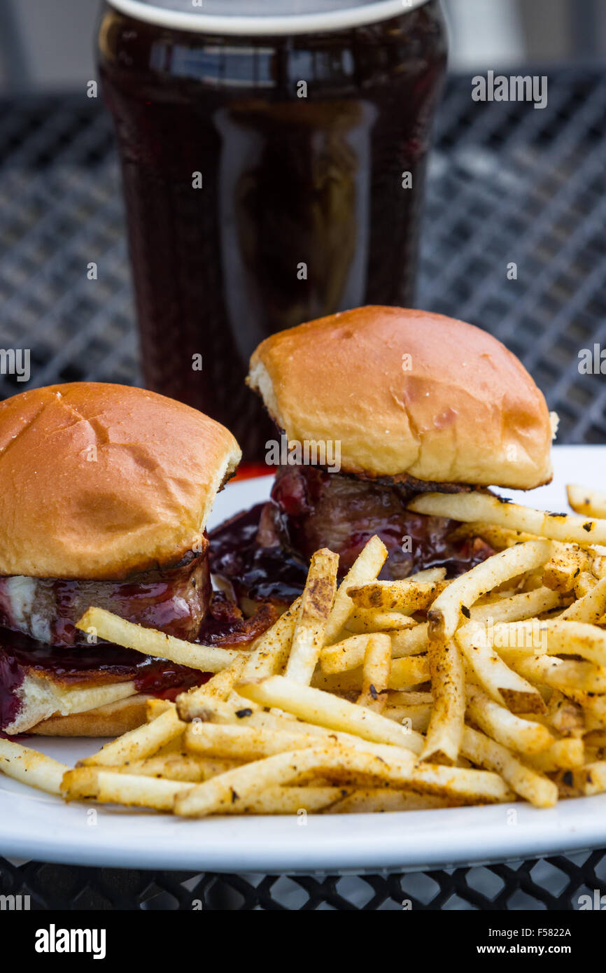serving of two tenderloin sliders with seasoned shoe string fries Stock ...