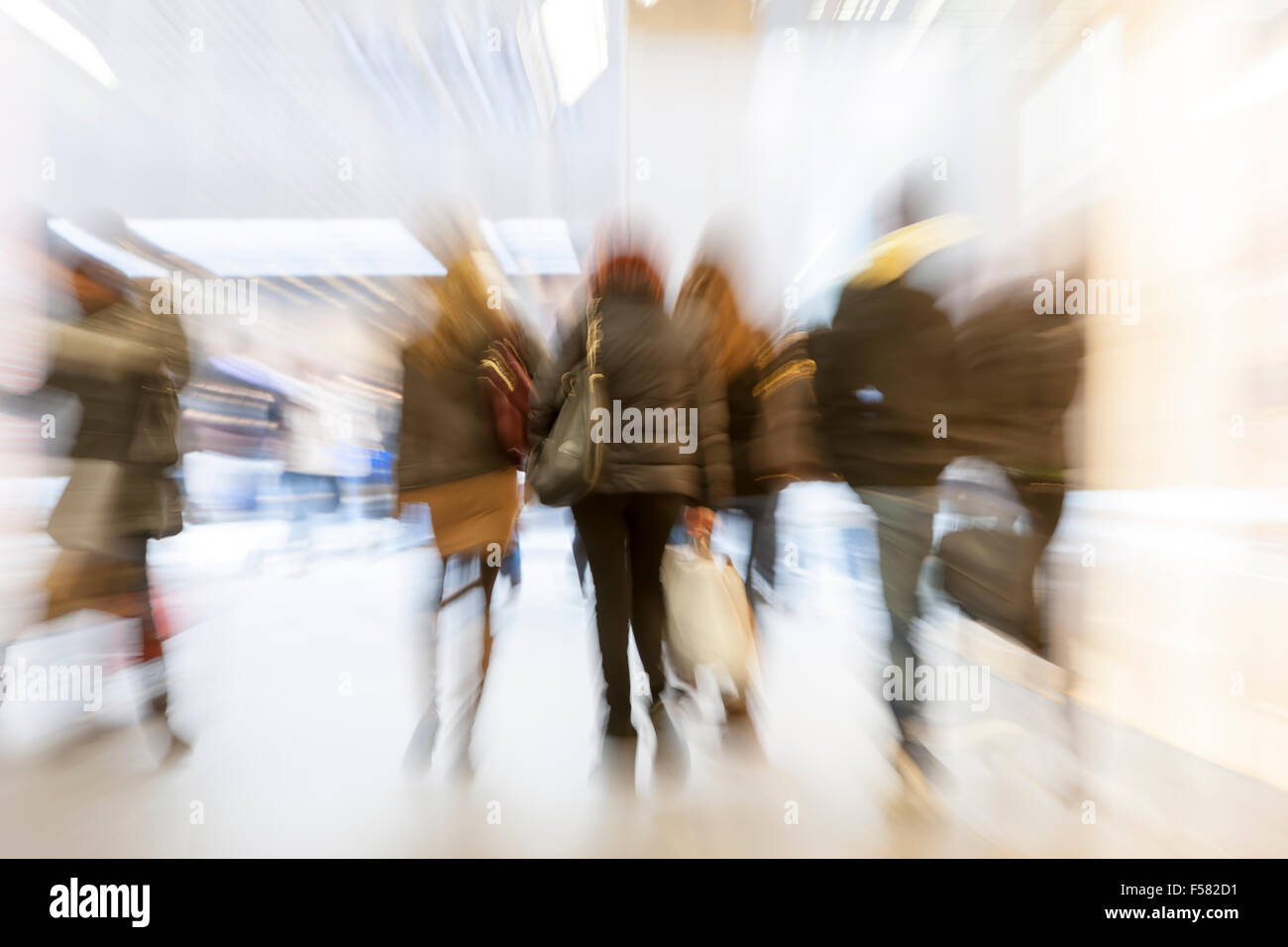 Crowd of people rushing through corridor, zoom effect, motion blur ...