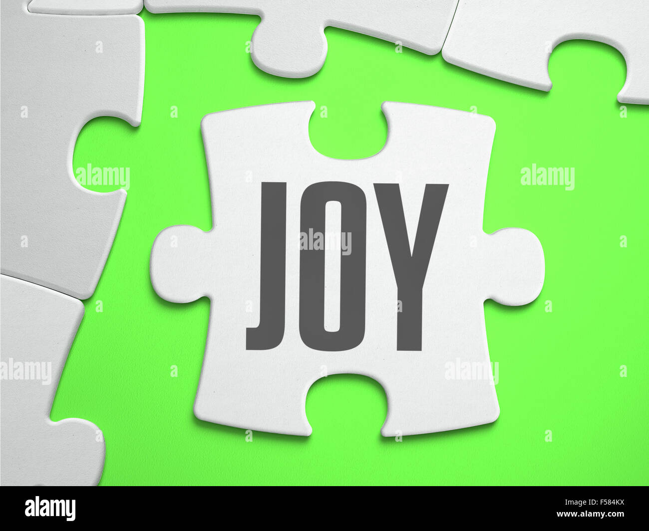 Joy - Jigsaw Puzzle with Missing Pieces. Bright Green Background. Close ...