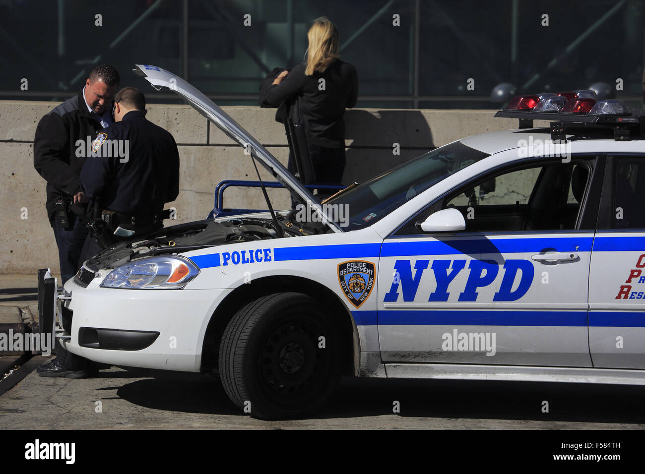 NYPD police officers waiting for help beside a breakdown police patrol ...