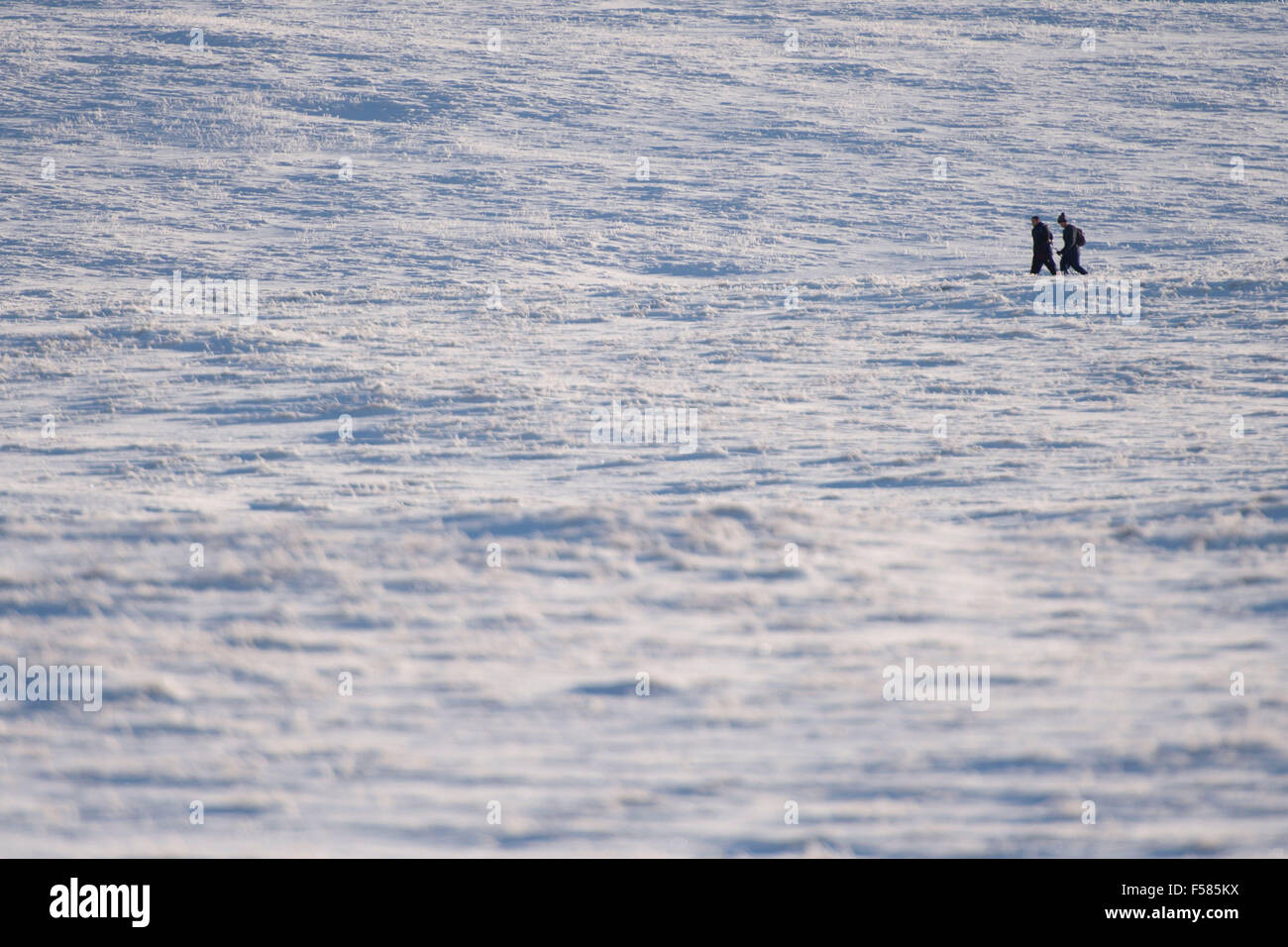 Walkers walk through heavy deep snow at Pen y Fan mountain, Brecon ...