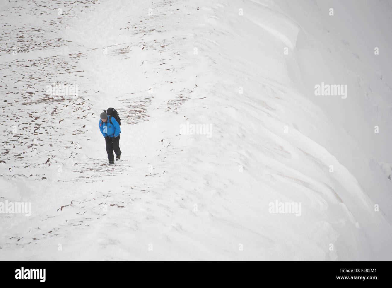 Walkers walk through heavy deep snow at Pen y Fan mountain, Brecon ...