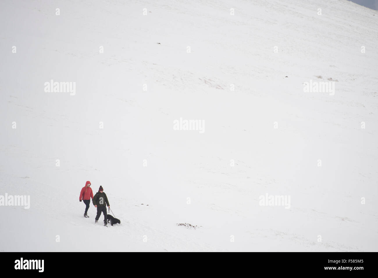 Walkers walk through heavy deep snow at Pen y Fan mountain, Brecon ...