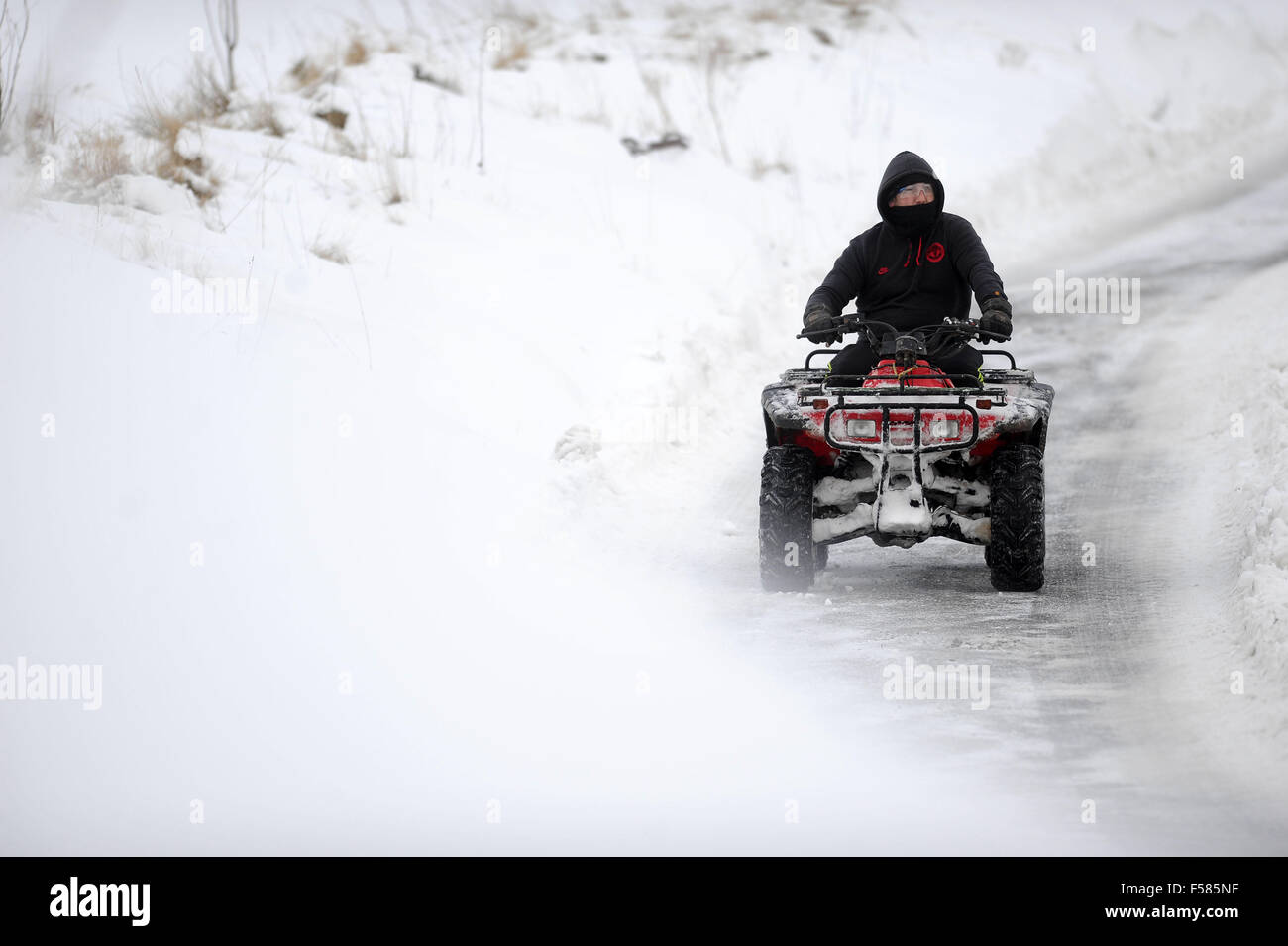 A man rides a quad bike in heavy snow in Rhondda, South Wales Stock ...