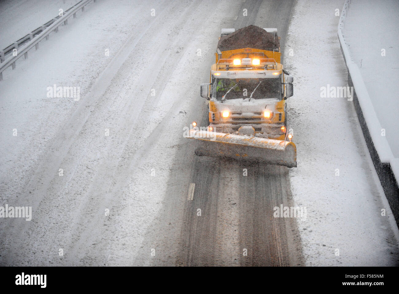 A snow gritter clears snow and ice from a motorway Stock Photo - Alamy