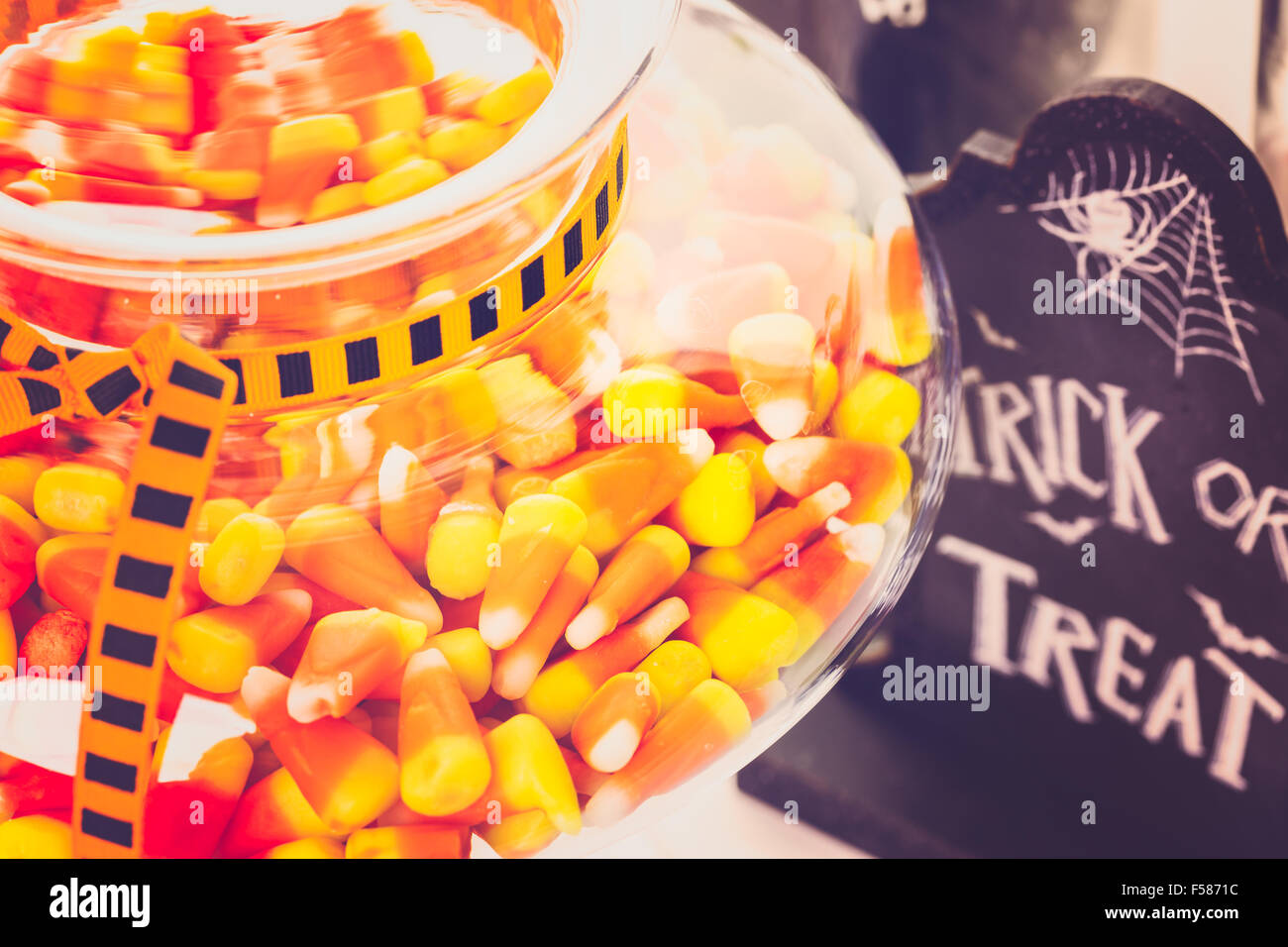 Candy corn in candy jar for Halloween treats Stock Photo - Alamy