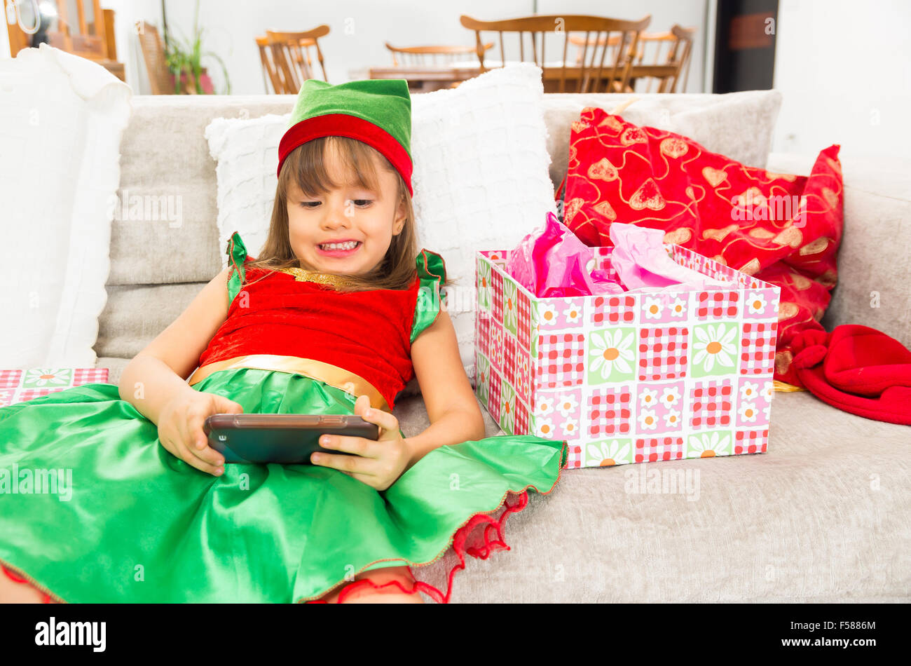Little girl dressed as Christmas elf holding mobile phone Stock Photo ...