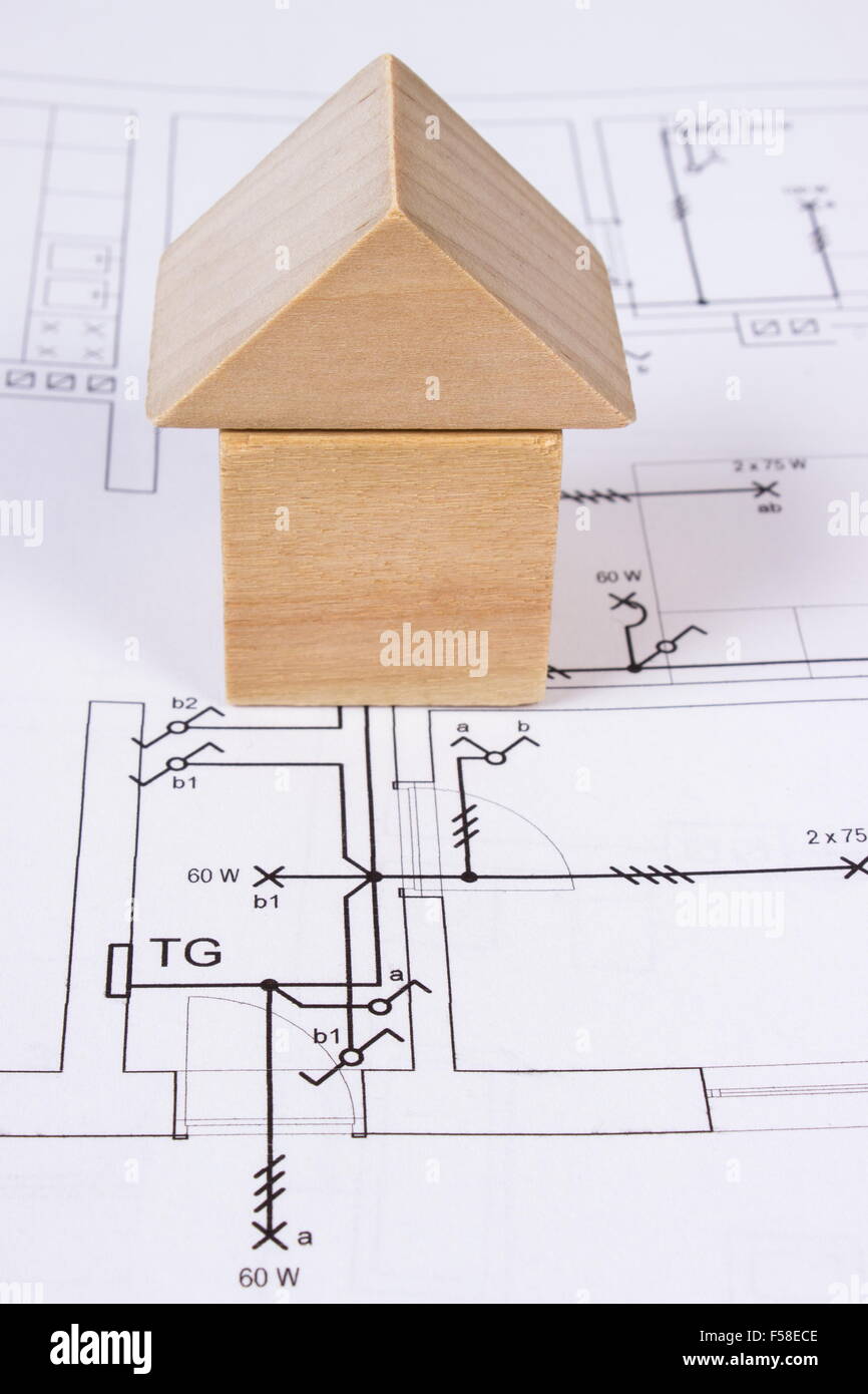 House shape made of wooden blocks lying on electrical construction ...