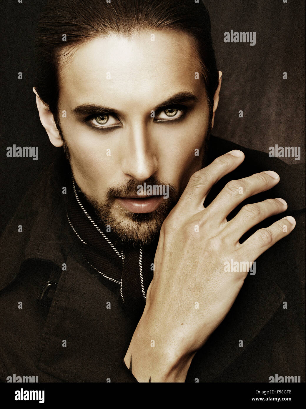 Haunting stare from a man with dark features Stock Photo - Alamy