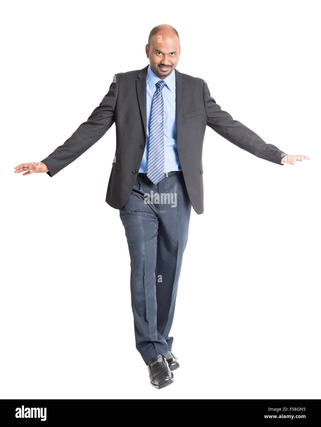 Full body Indian businessman walking balance , front view on plain ...