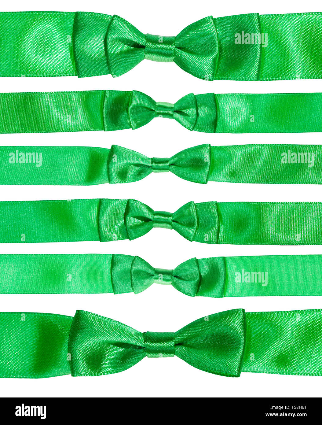 set of real bow knots on green satin ribbons isolated on white ...