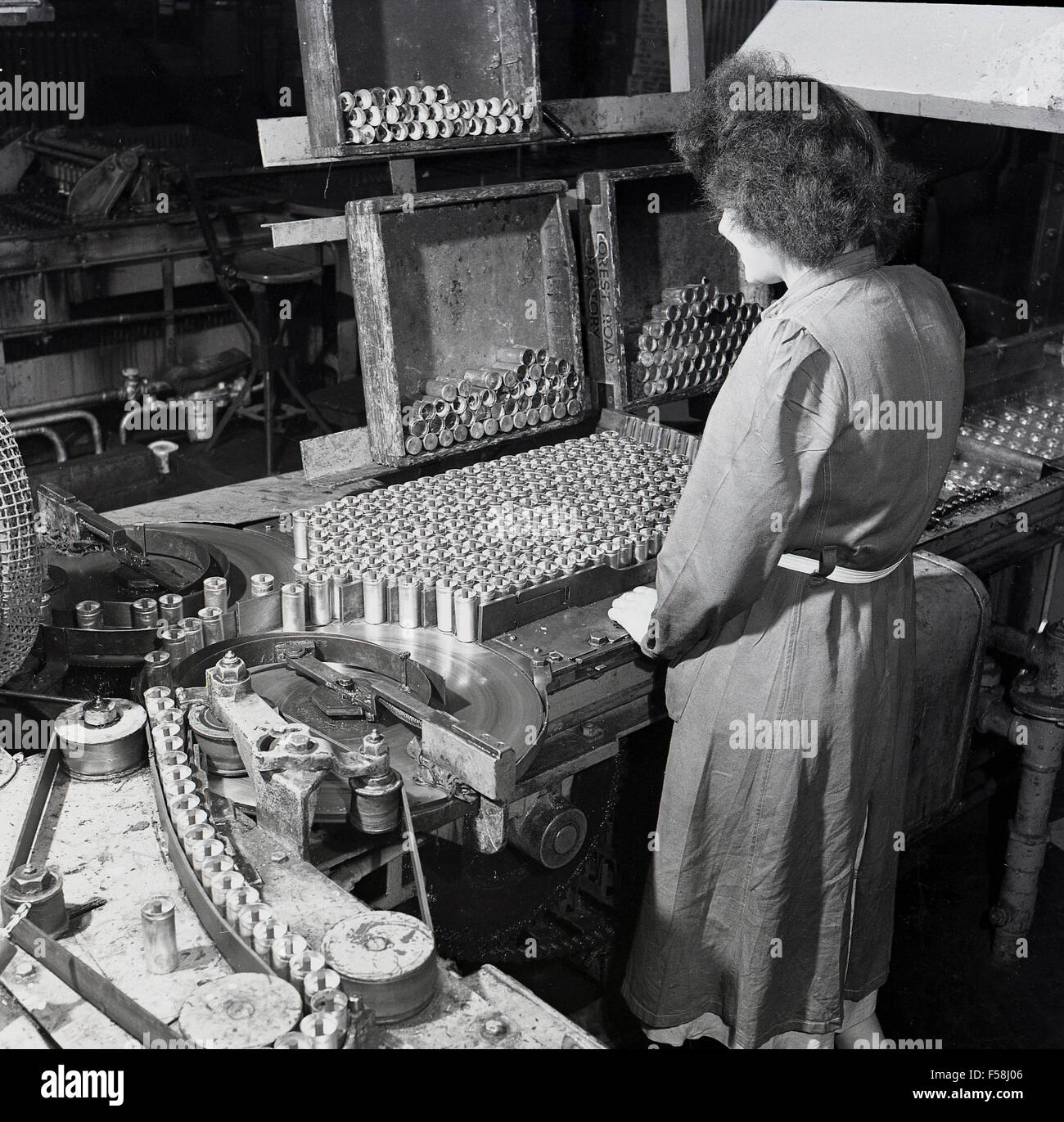 1950s historical, female operative works on a manufacturing production ...