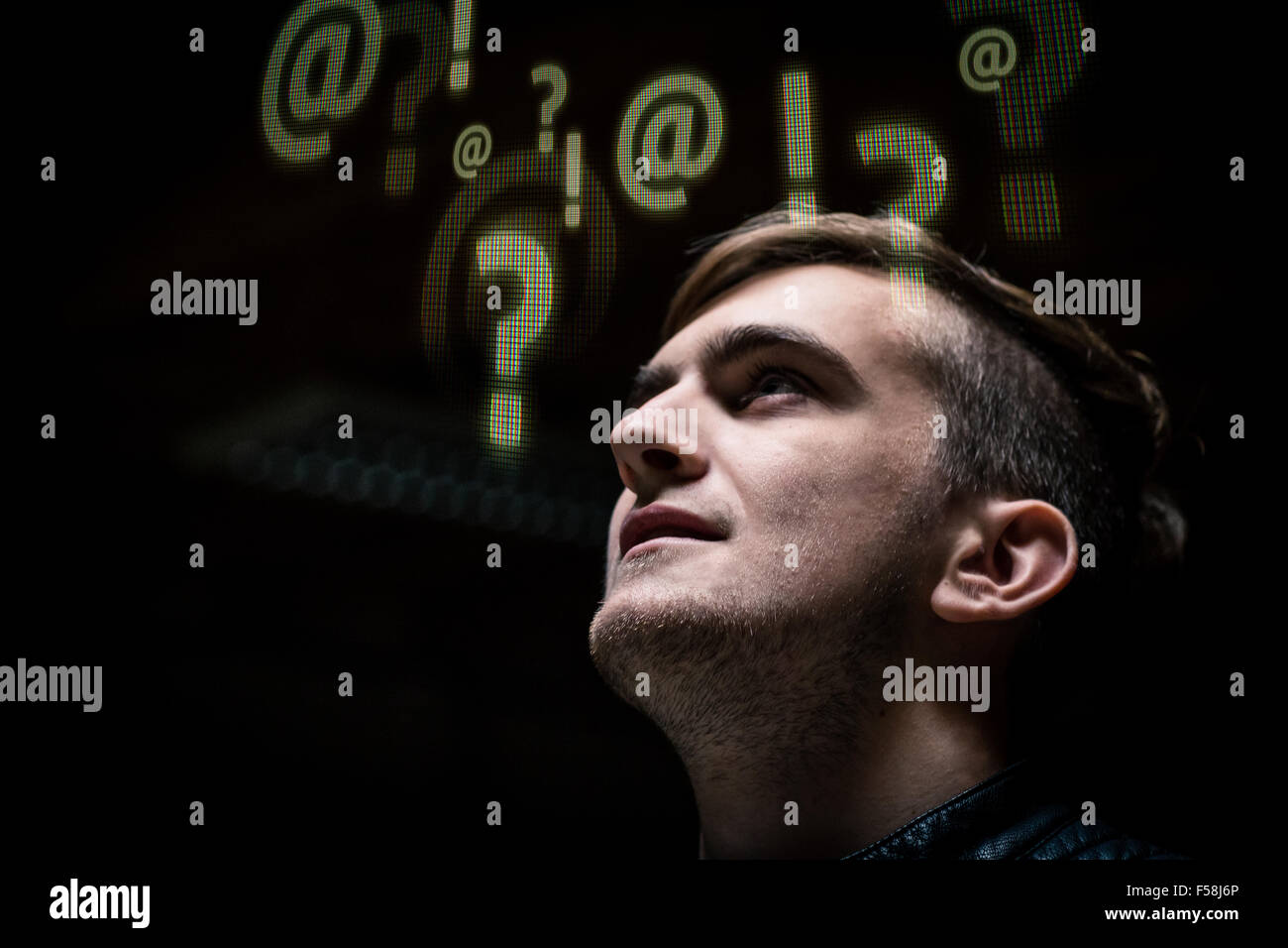 Profile of a young man face under lights. Question marks and ...