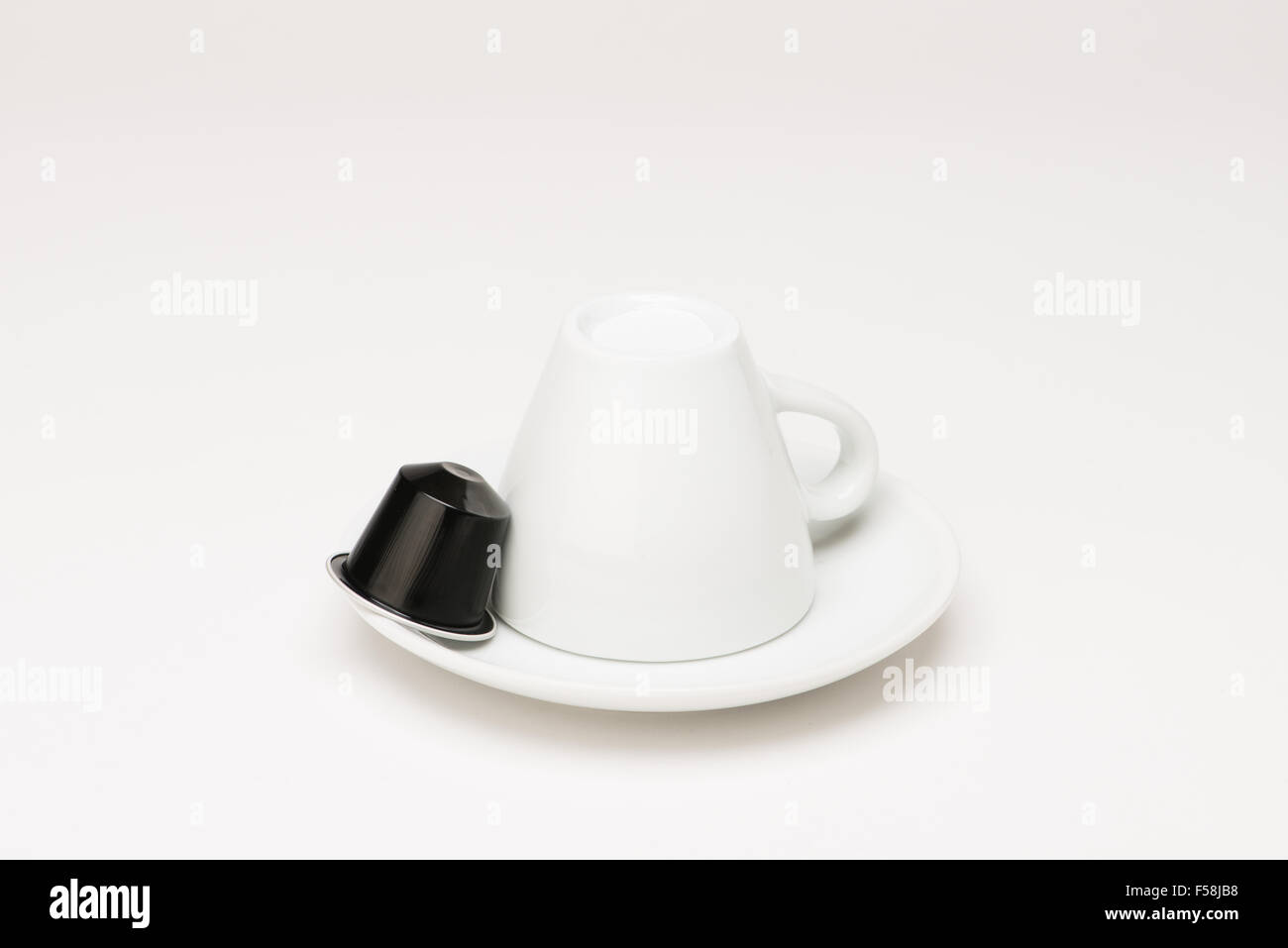Coffee cup with capsule isolated on white Stock Photo - Alamy