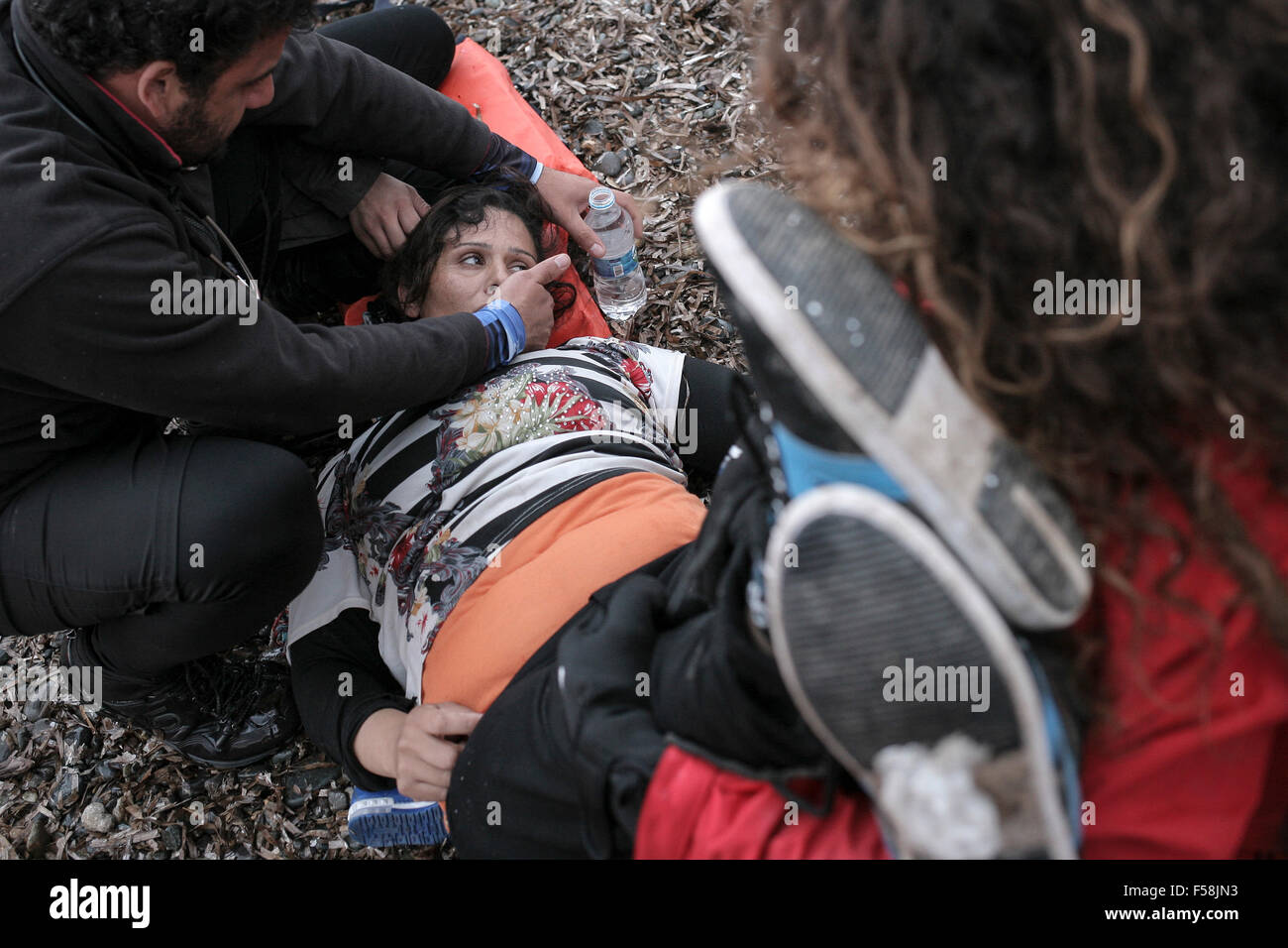Volunteers try to help a woman after she fainted just after she ...