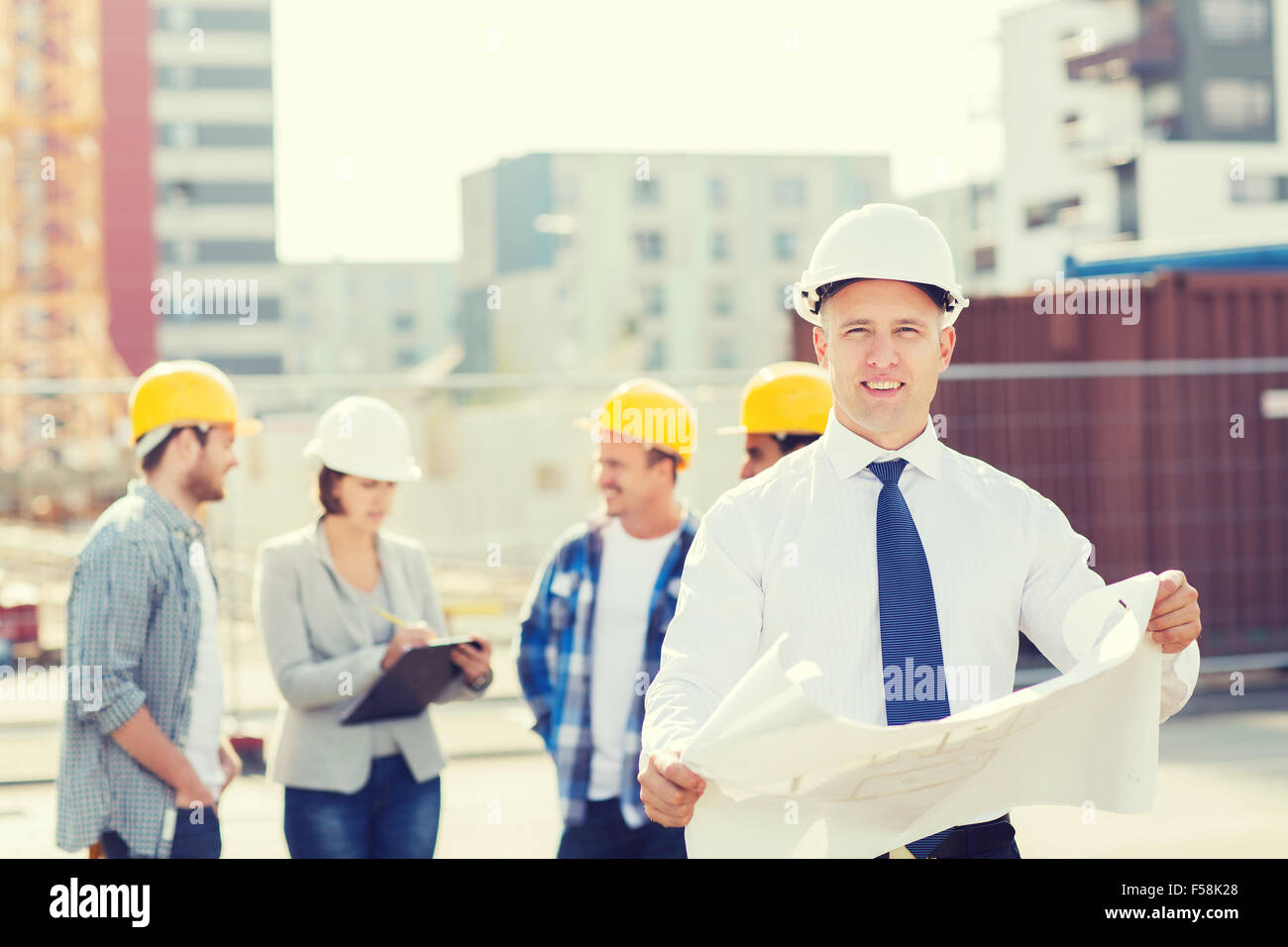 group of builders with tablet pc and blueprint Stock Photo - Alamy
