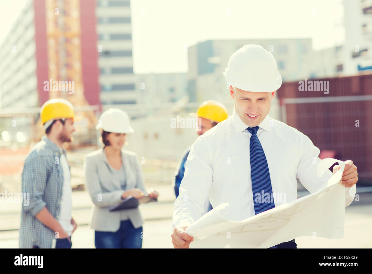 group of builders with tablet pc and blueprint Stock Photo - Alamy