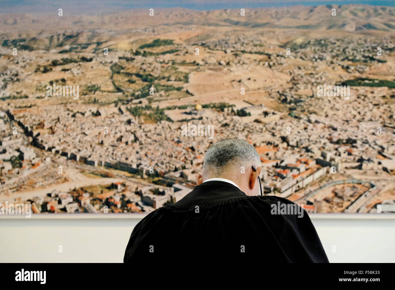 An Israeli lawyer stands next to a photograph depicting aerial view of ...