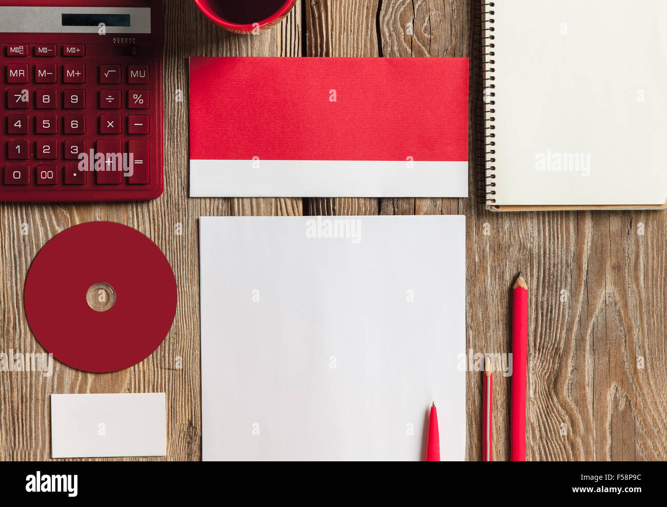 The mockup on wooden background with red calculator Stock Photo - Alamy