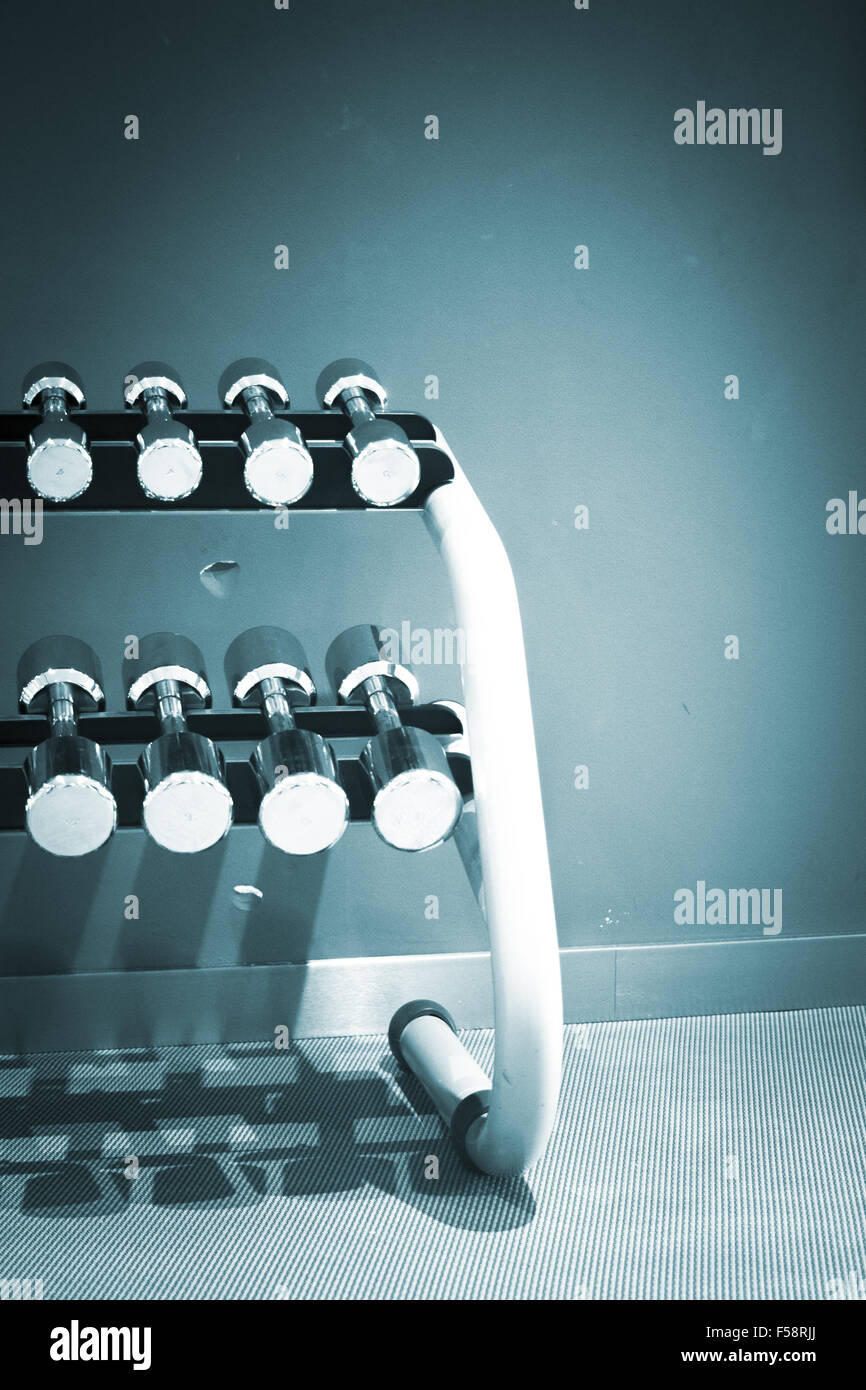 Dumbbell gym metal weights rack in exercise room in sports bodybuilder ...