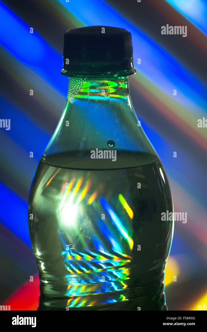 Carbonated lemonade soda bottle on colors background Stock Photo - Alamy