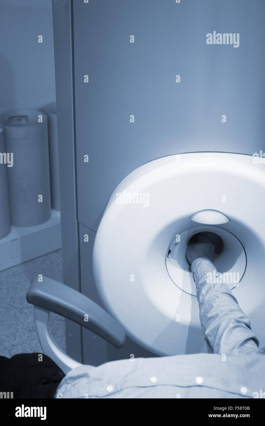 Patient in fully open MRI CAT Scan scanning arm, elbow, forearm, hand ...