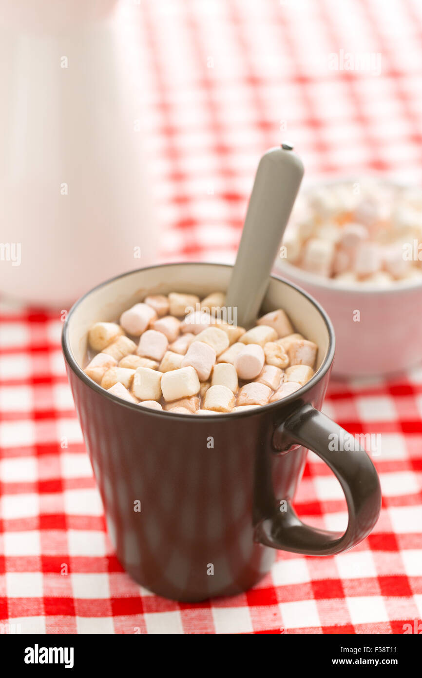 Cocoa drink with marshmallows in mug on checkered tablecloth Stock ...