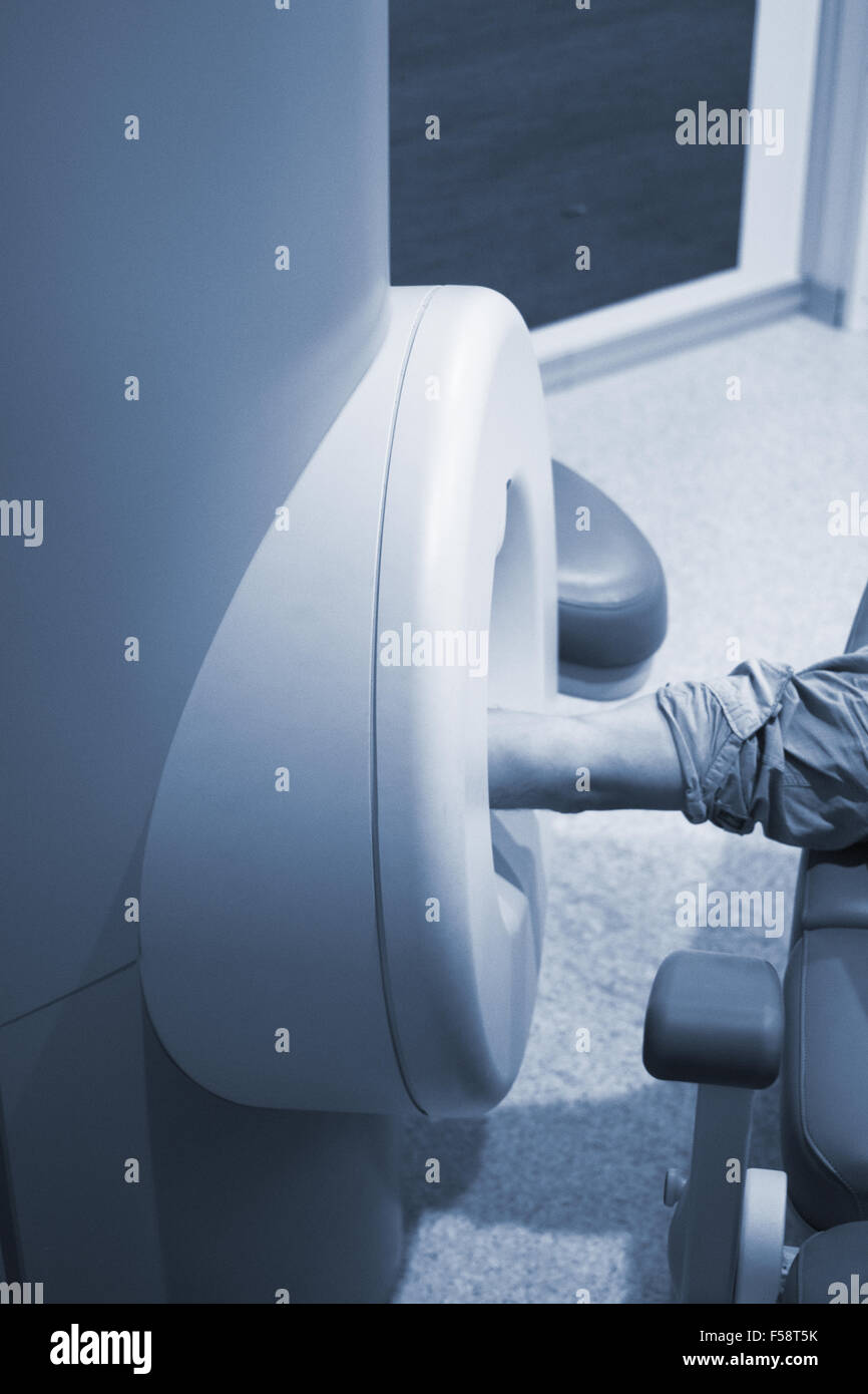 Patient in fully open MRI CAT Scan scanning arm, elbow, forearm, hand ...