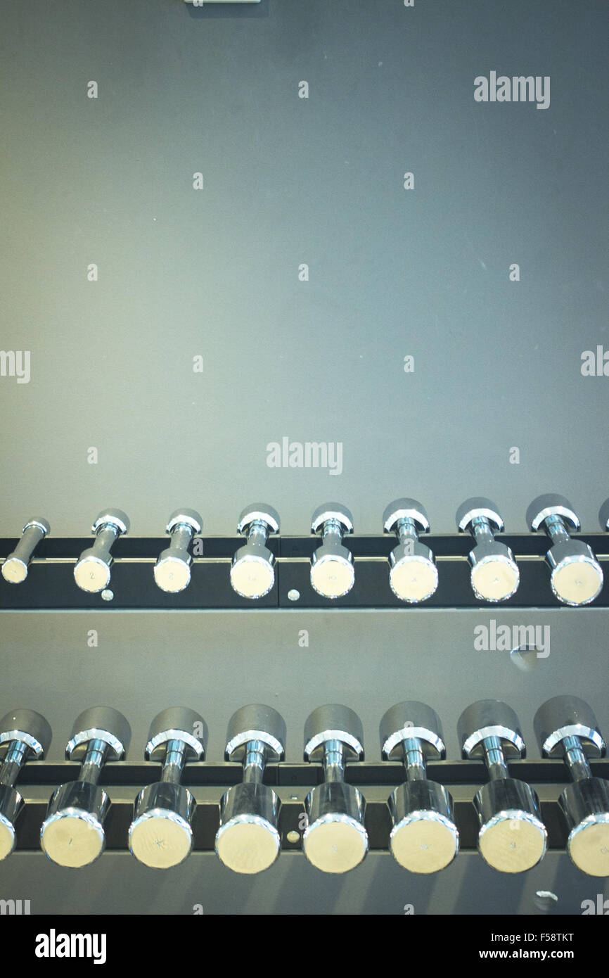 Dumbbell gym metal weights rack in exercise room in sports bodybuilder ...