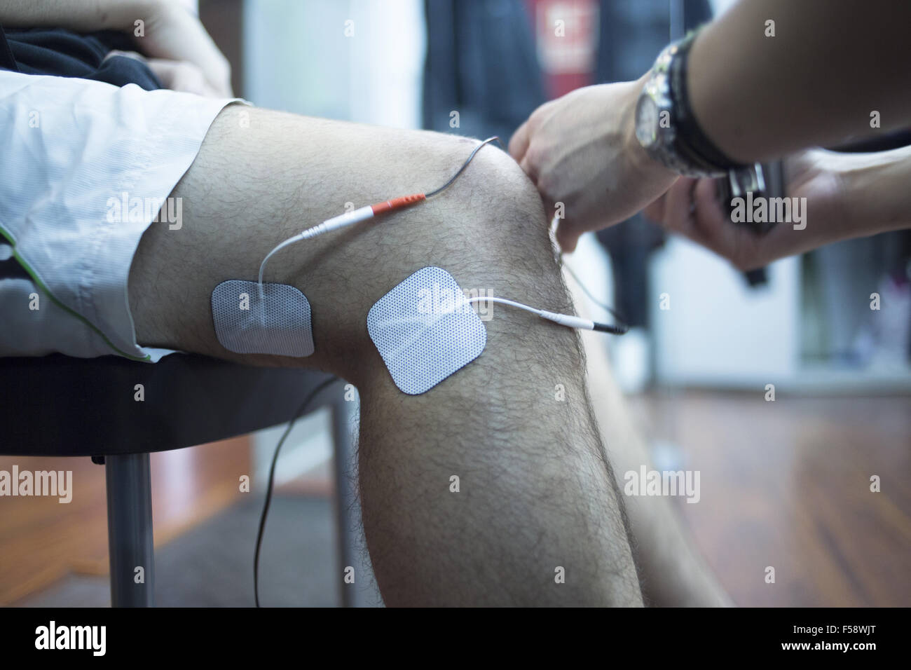Patient knee, leg, thigh and calf in physiotherapy electrical impulse ...