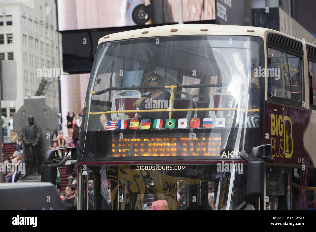 Woman rides an NYC tour bus through Times Square on 7th Ave. NYC Stock ...
