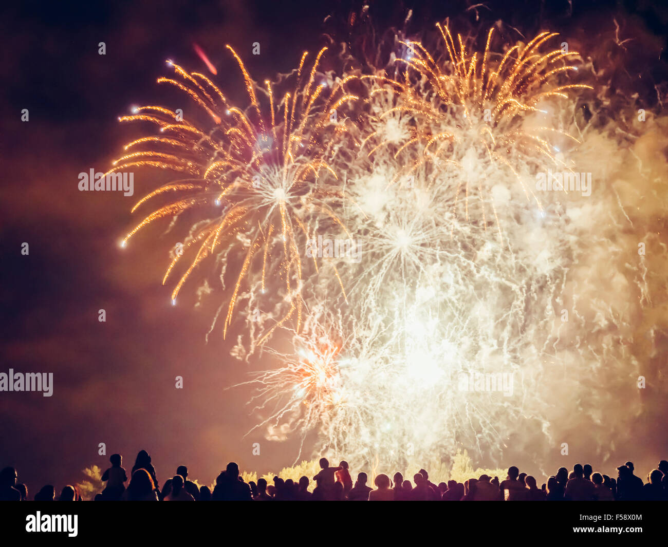 Crowd wathcing fireworks and celebrating Stock Photo - Alamy
