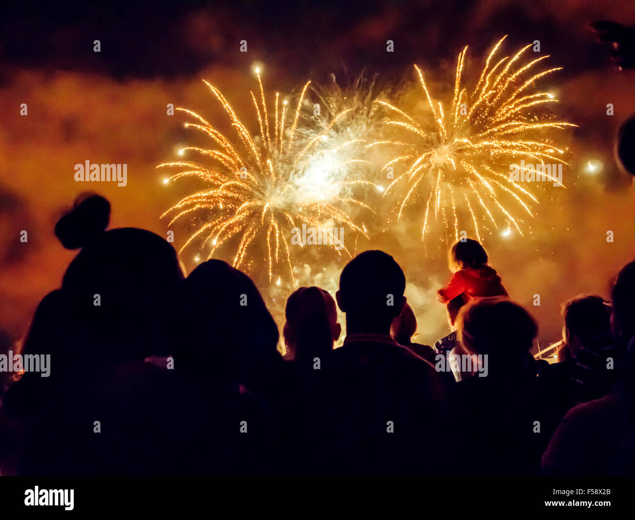 Crowd wathcing fireworks and celebrating Stock Photo - Alamy
