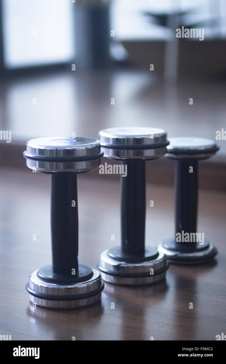 Dumbbell gym metal weights on wooden floor in exercise room in gym ...
