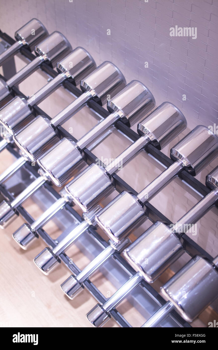 Dumbbells gym metal weights in exercise room in gym health club fitness ...