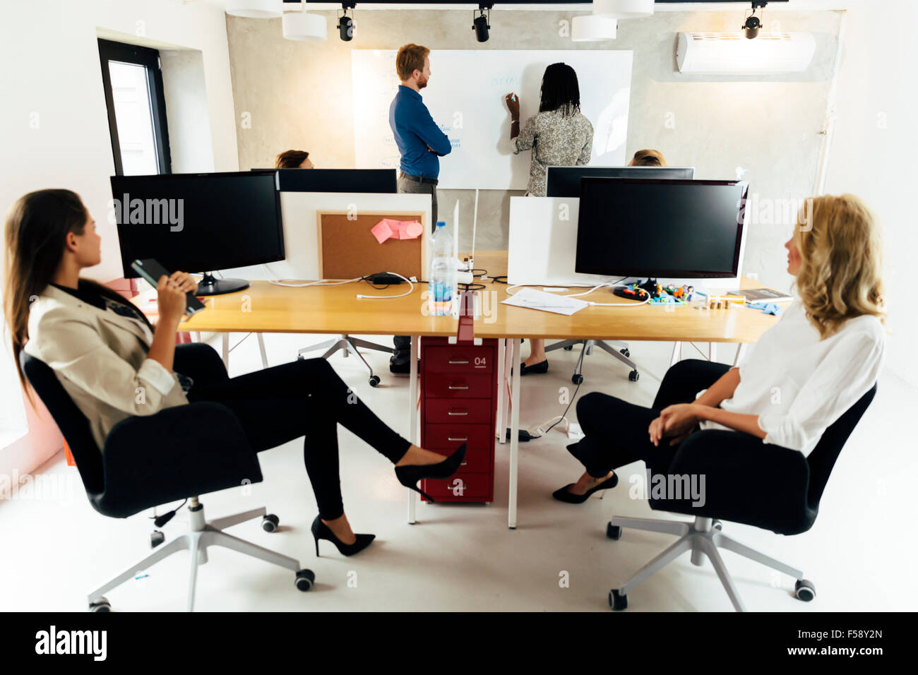 Business people at seminar improving their skills and learning new ...