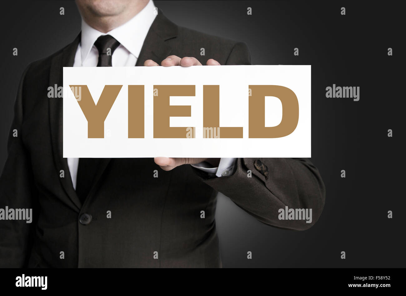 yield sign held by businessman concept Stock Photo - Alamy