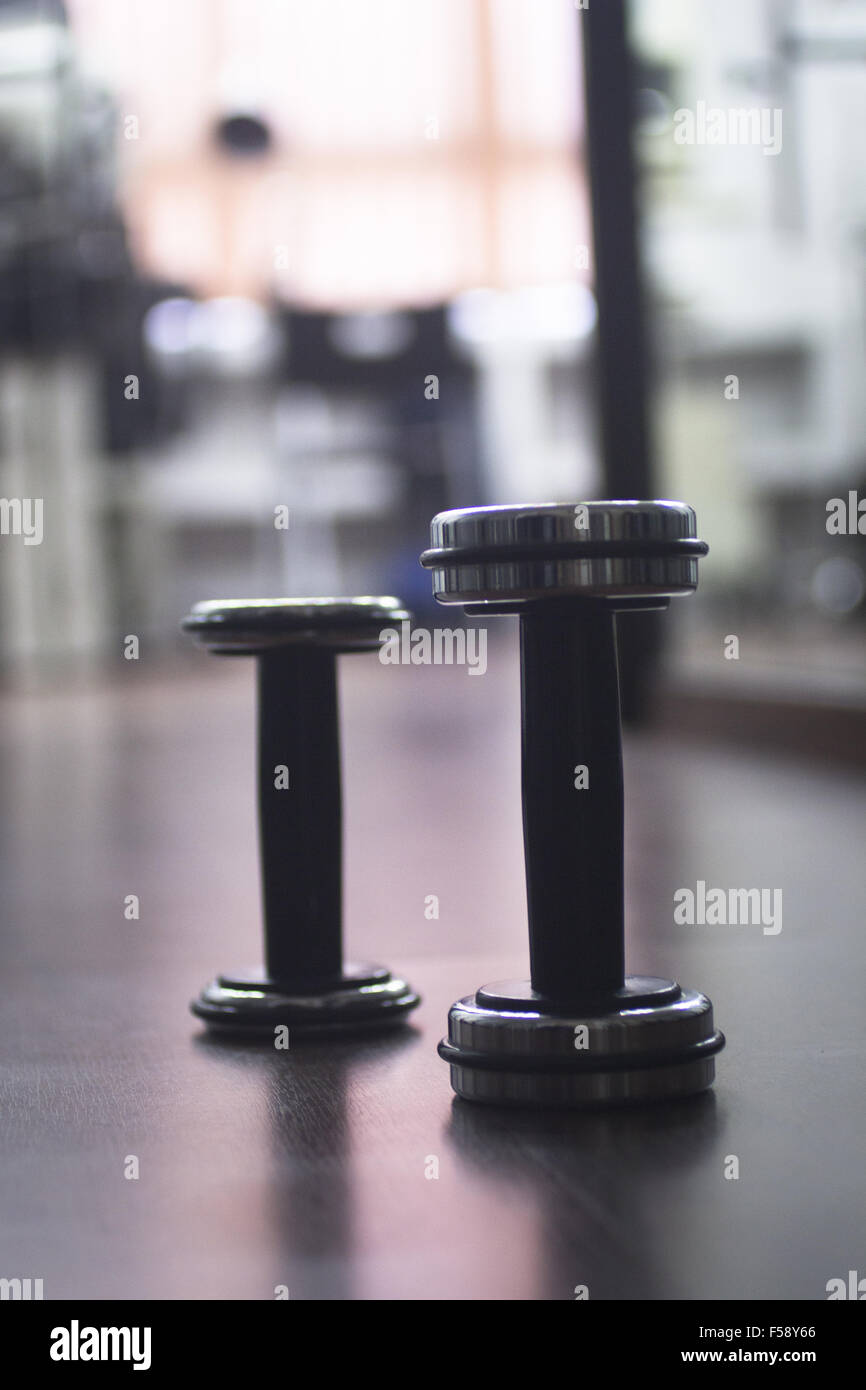 Dumbbell gym metal weights on wooden floor in exercise room in gym ...