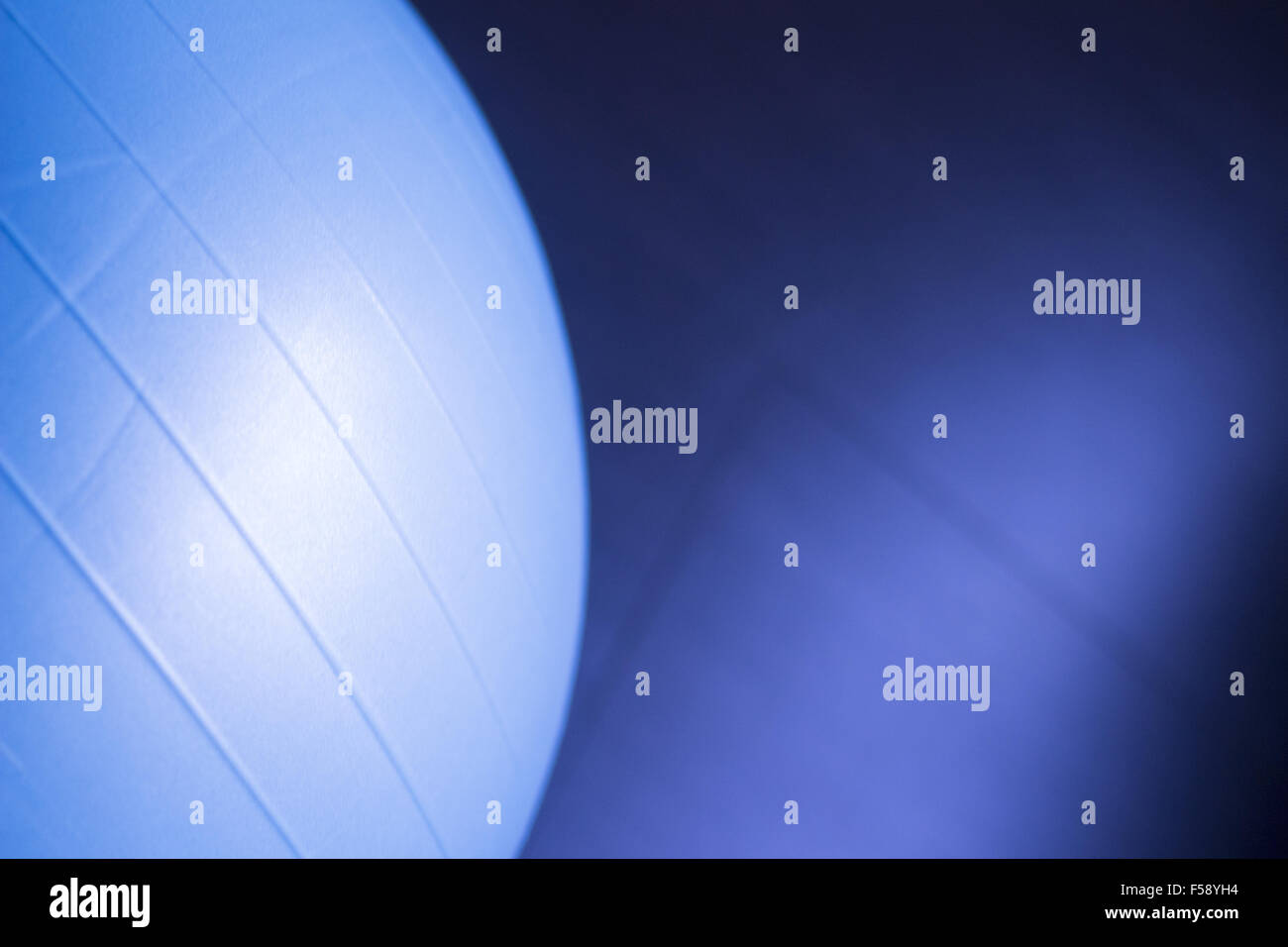 Blue pilates gym aerobics exercise ball in gymnasium Stock Photo - Alamy