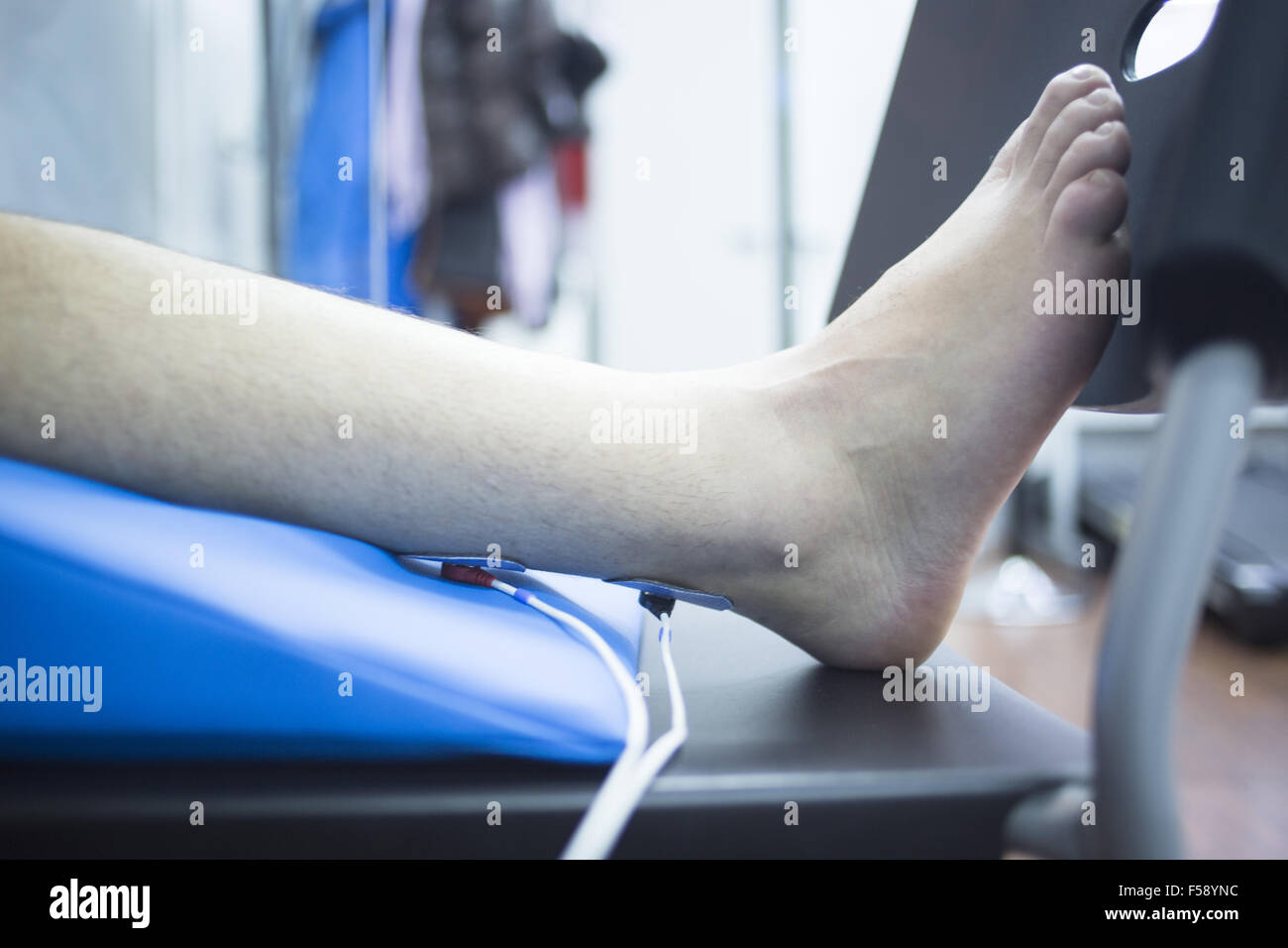 Patient knee, leg, thigh and calf in physiotherapy electrical impulse ...
