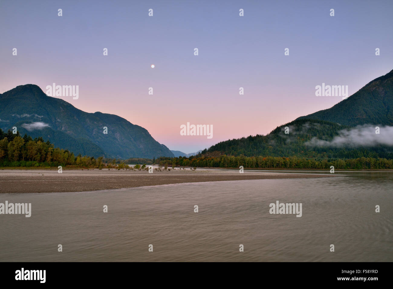 Morning skies with full moon over the Fraser River, Hope, British ...