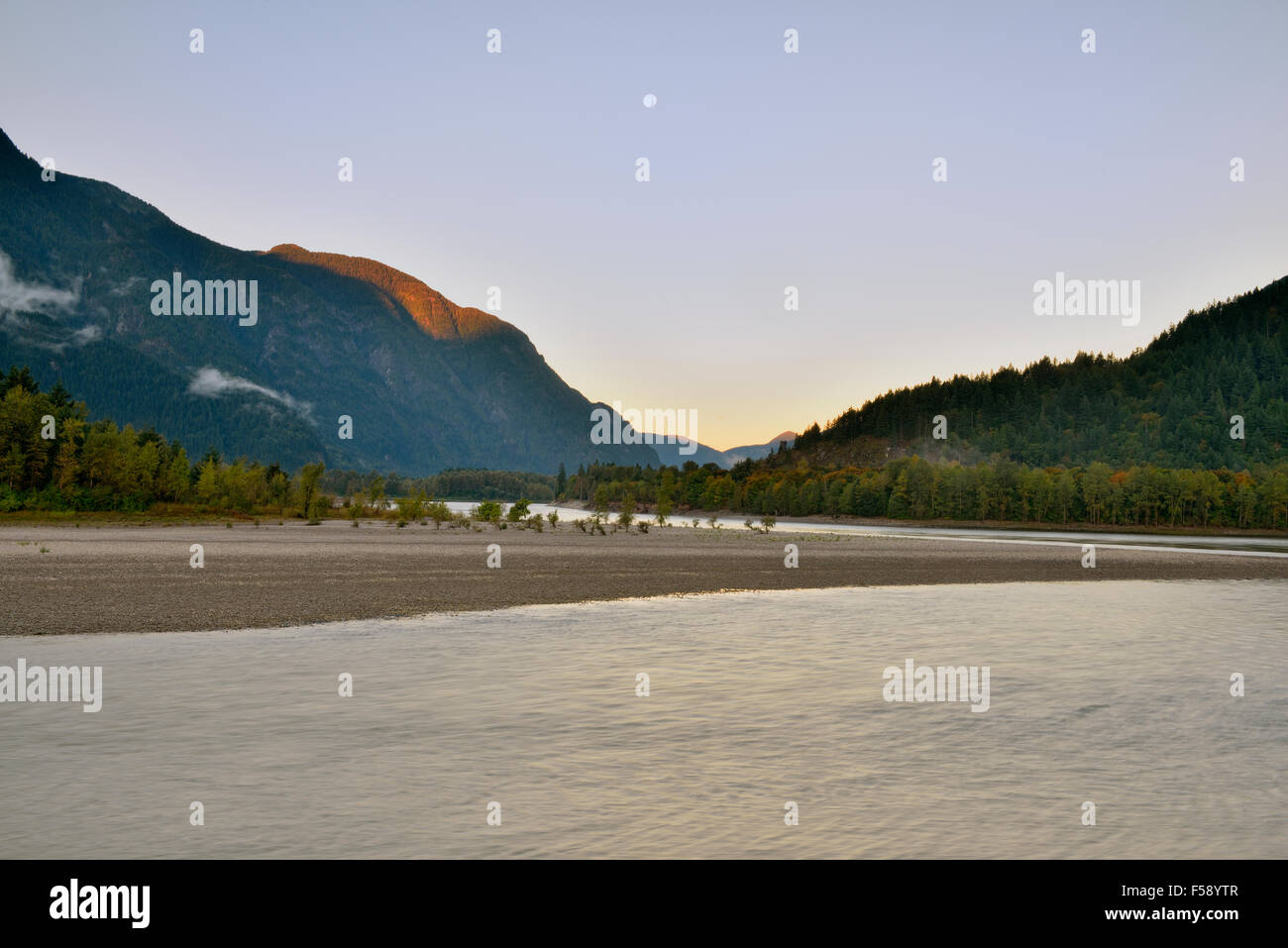 Morning skies with full moon over the Fraser River, Hope, British ...