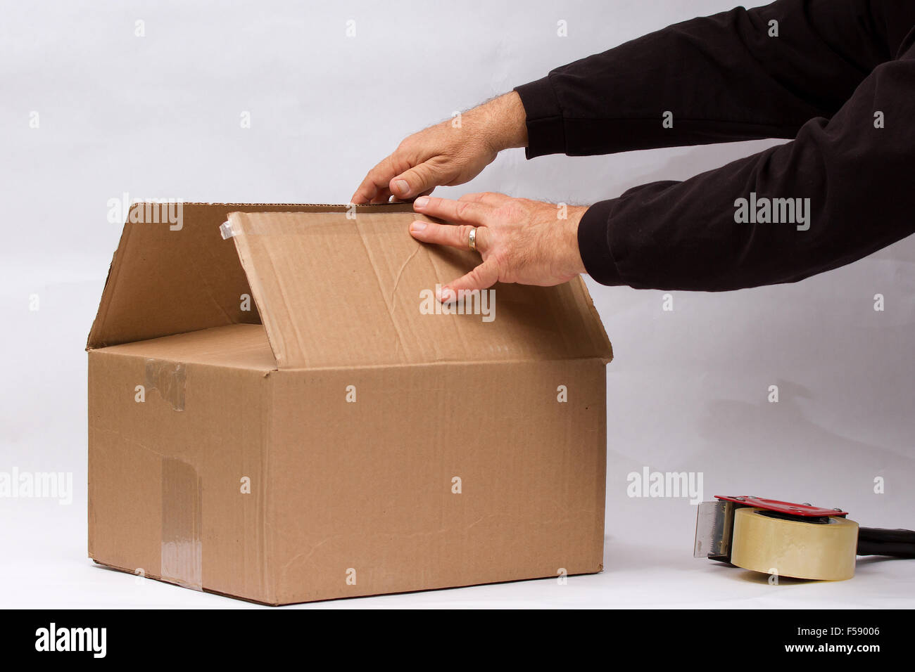 Packaging a box for shipping Stock Photo - Alamy