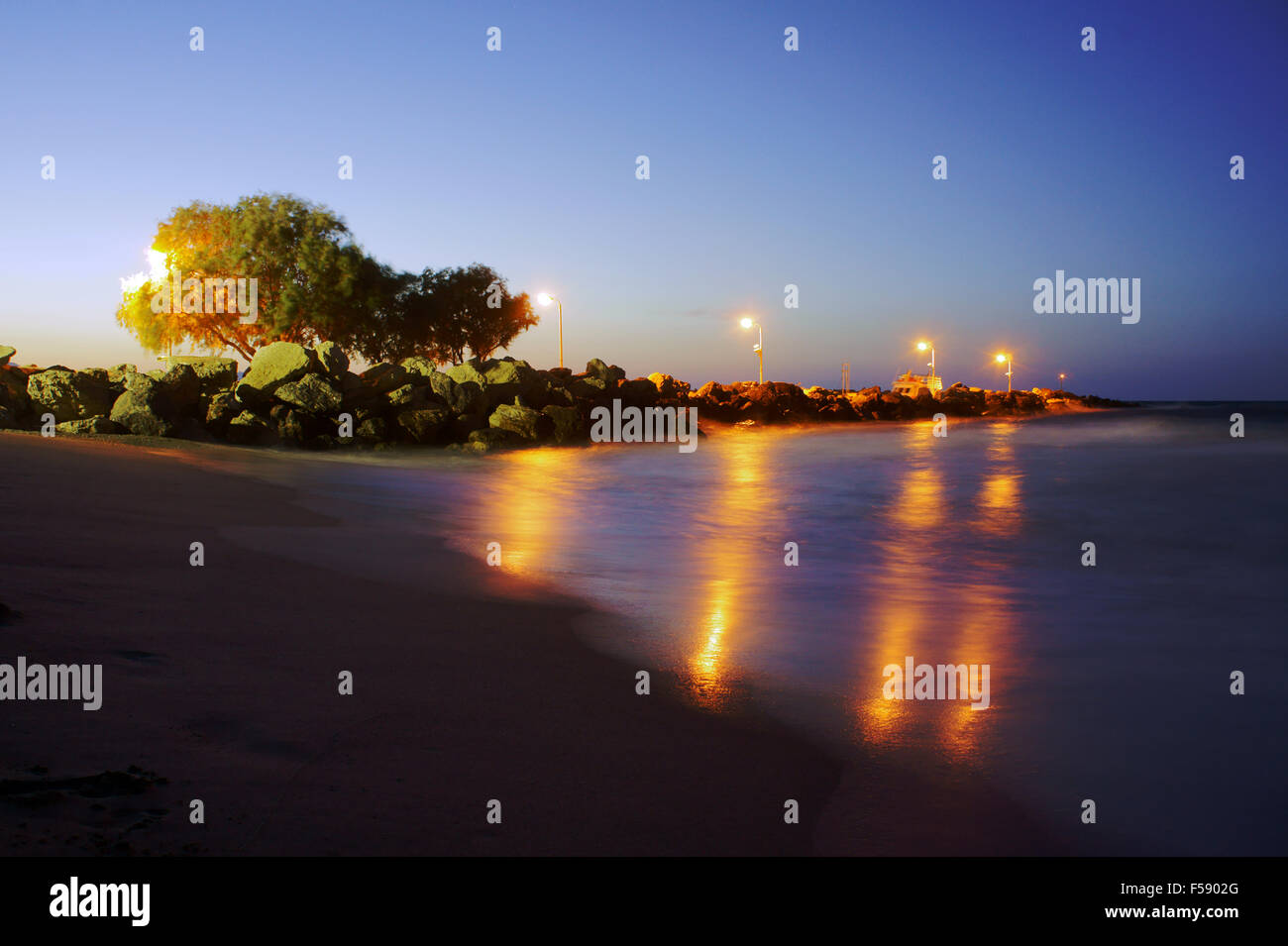 Breakwater and harbor on the island of Crete in the evening Stock Photo ...