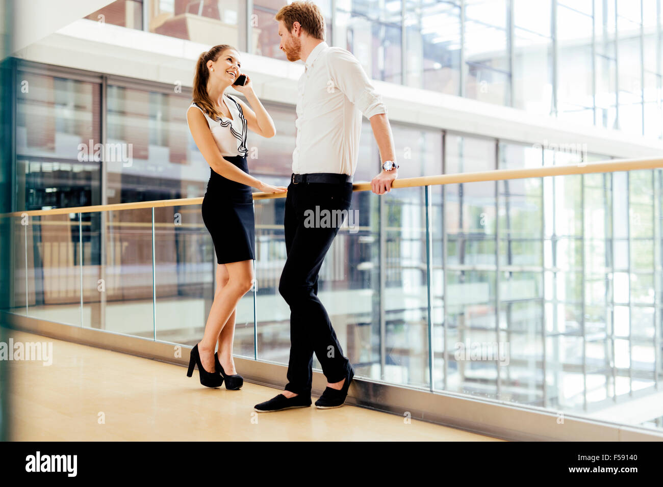 Business people having a break and using phones Stock Photo - Alamy