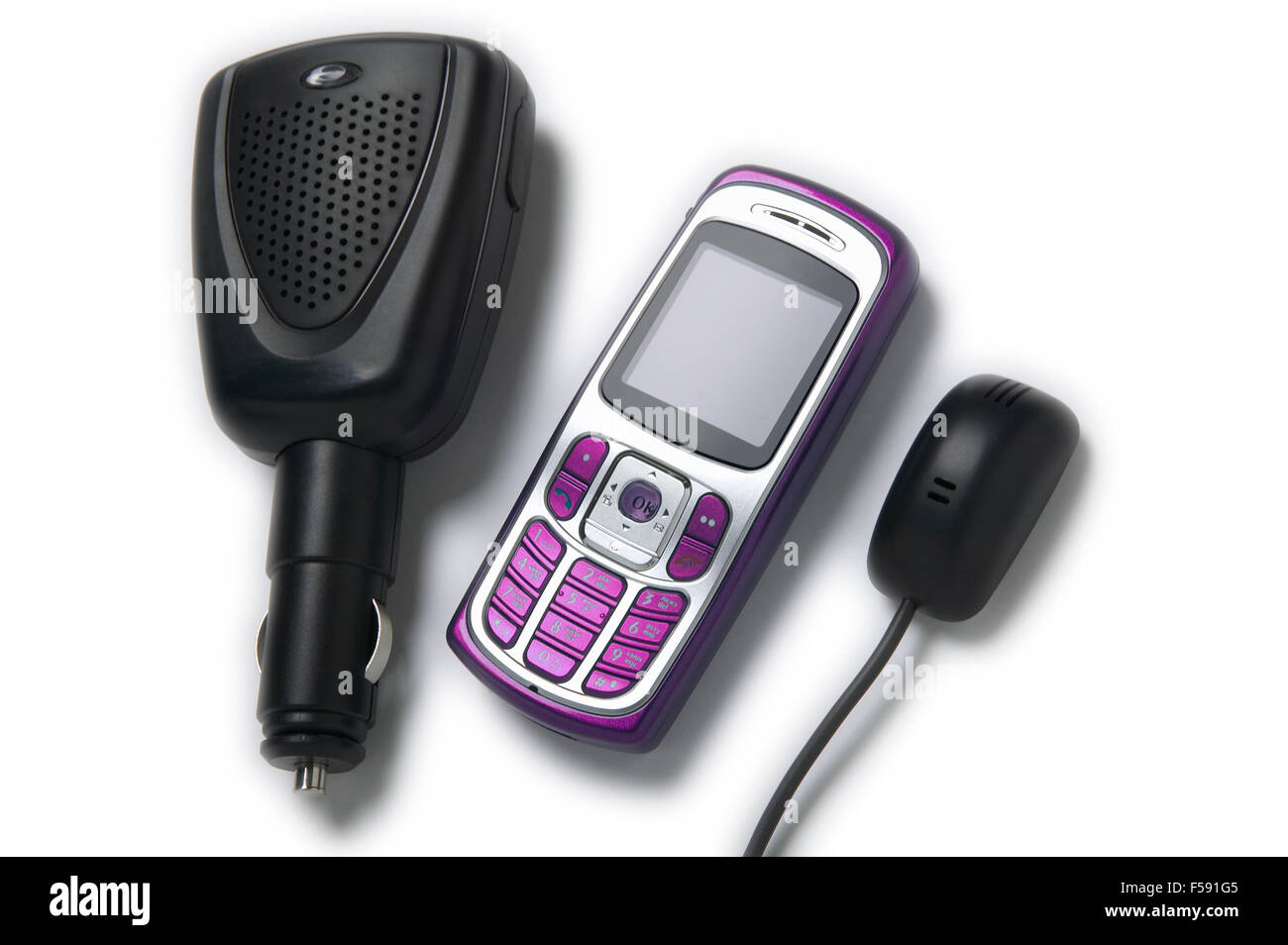 Bluetooth Headset with car charger and mobile phone isolated on white ...